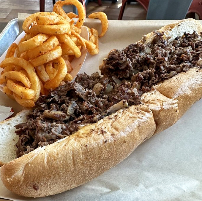 The humble cheesesteak, elevated to art form: thinly sliced beef, melted cheese, and a roll that's both sturdy and yielding.