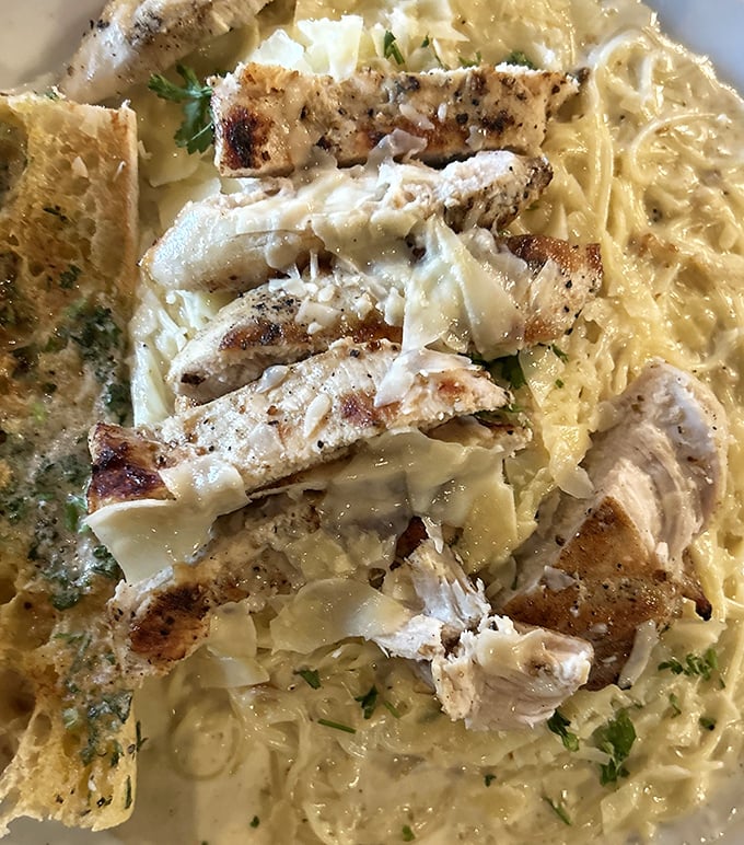 Chicken Alfredo that doesn't hide behind excess &ndash; tender slices of chicken resting on pasta bathed in creamy sauce that whispers rather than shouts.