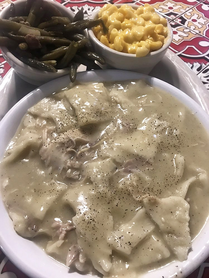 Chicken and dumplings swimming in peppery cream gravy - the kind of dish that makes you understand why comfort food got its name.