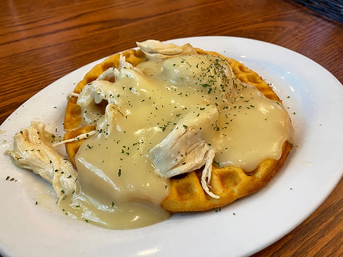Breakfast meets dinner in this chicken and waffle masterpiece, where savory poultry lounges on a golden waffle throne under a blanket of creamy gravy.