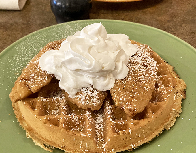Golden waffle perfection crowned with a cloud of whipped cream. Like a breakfast tiara that makes you feel like royalty at 8 AM.