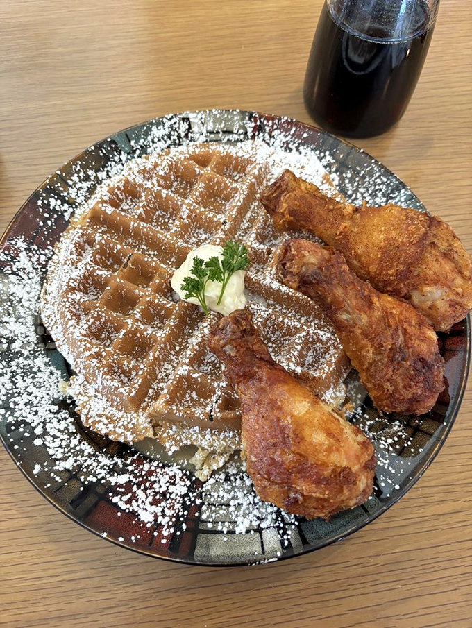 Chicken and waffles: the culinary odd couple that works so beautifully together, dusted with powdered sugar for that sweet-savory magic.