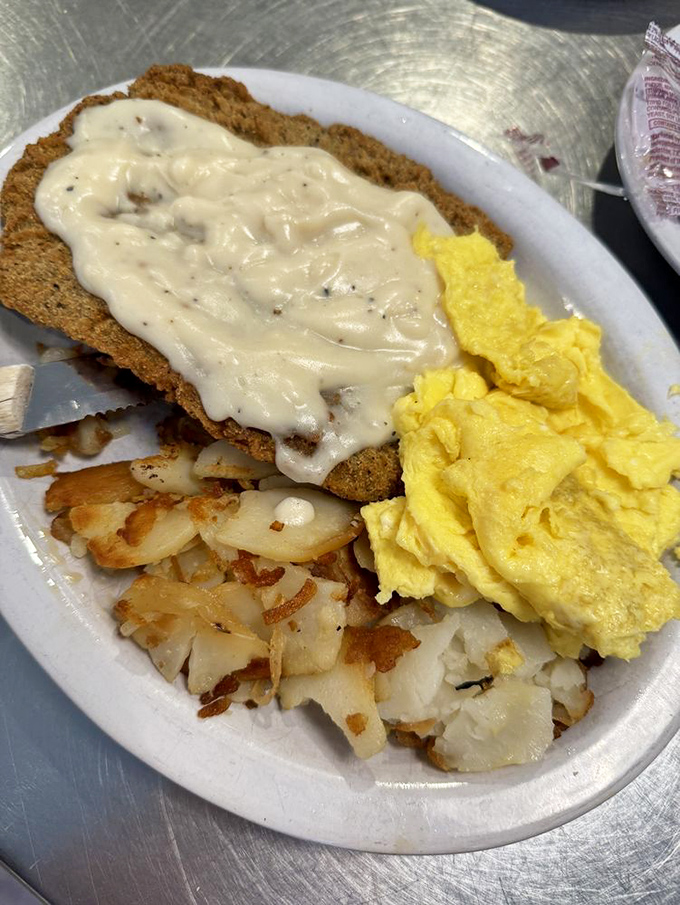 Biscuits and gravy that would make your grandmother both jealous and proud, with a side of mixed vegetables pretending to make it healthy.