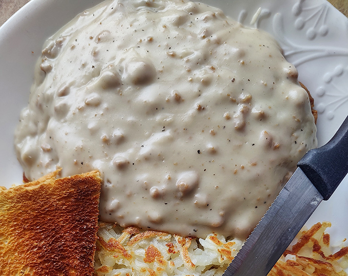 Chicken fried steak swimming in peppery gravy – the kind of dish that makes you understand why people write country songs about home.