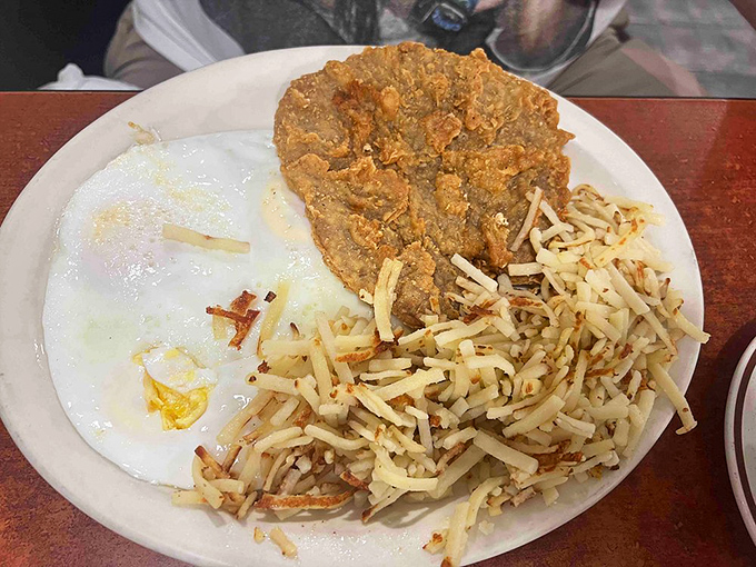 Country fried steak with those legendary hash browns &ndash; a plate that says "you won't need dinner" in the most delicious way possible.