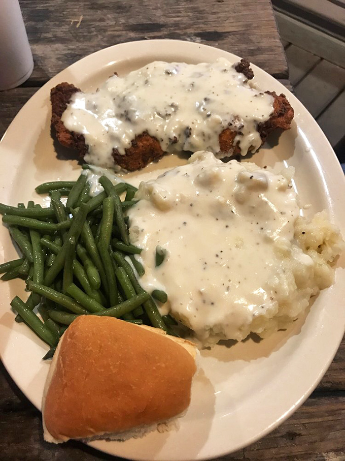 Southern comfort on a plate. This chicken fried steak smothered in peppery cream gravy could make a vegetarian question their life choices.