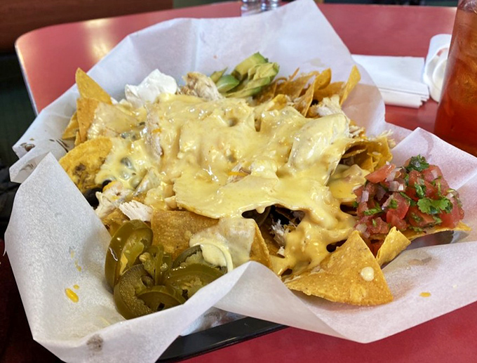 Nachos that defy gravity and good sense &ndash; a mountain of melty cheese, jalape&ntilde;os, and happiness on crispy tortilla real estate.