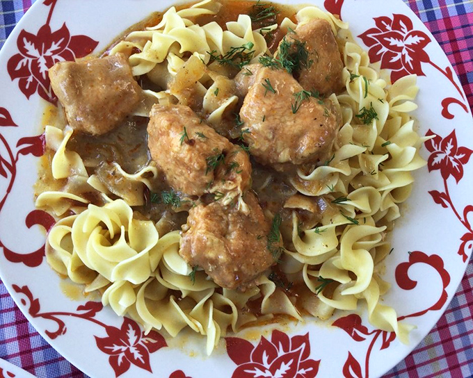 Chicken Paprikash that makes you understand why people write songs about food. Those tender morsels nestled on egg noodles are what comfort food dreams are made of.