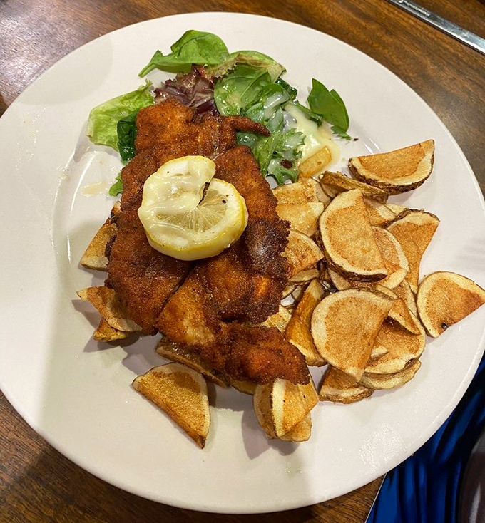 A perfectly breaded schnitzel with a squeeze of lemon that brightens the whole plate&mdash;crispy on the outside, tender within, like the best of us.