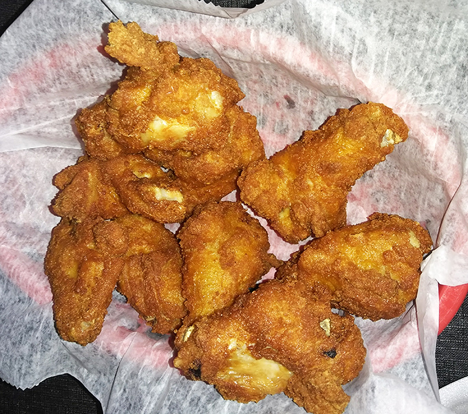 Fried chicken wings that crackle with each bite, revealing juicy meat within. The kind of wings that make you wonder why anyone bothers with fancy food.