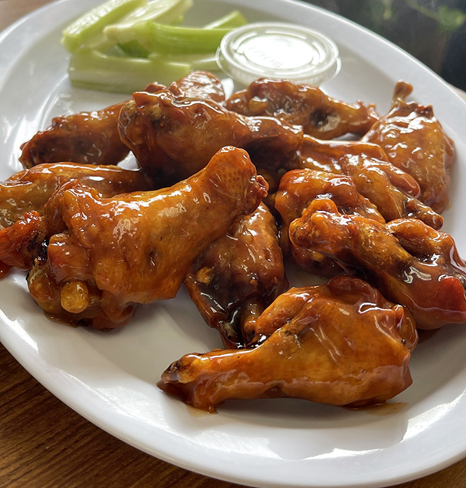 These wings aren't just sauced; they're baptized. Glistening with what appears to be BBQ glory, they're the kind of wings that require extra napkins and no shame.