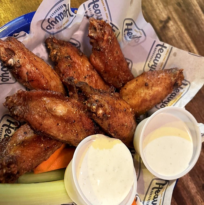 Wings that make you question why we even bother with utensils. Crispy, saucy perfection with cooling dips standing by.