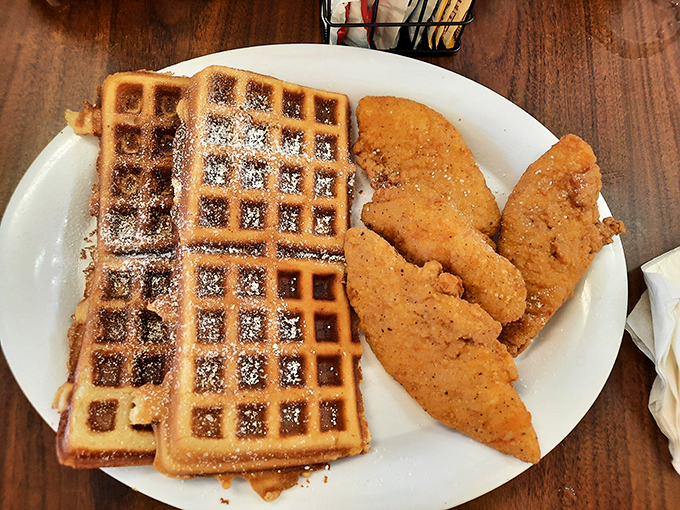 The chicken and waffle combo that settles the breakfast-or-lunch debate with a definitive "Why not both?" Dusted with powdered sugar for good measure.