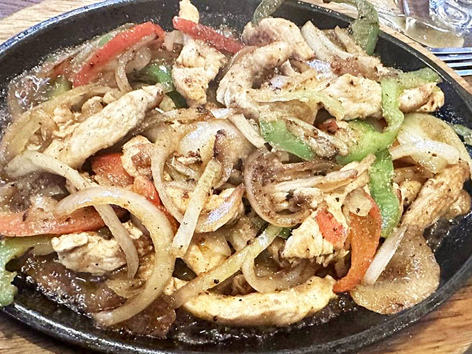 Sizzling fajitas that announce their arrival before you see them. That perfect char on the chicken is what food dreams are made of.