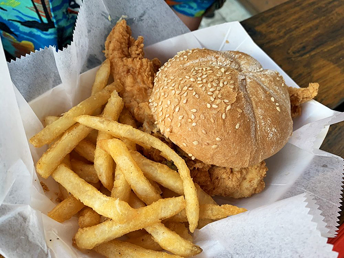 A sandwich that means business &ndash; golden-fried goodness nestled in a sesame bun with crispy fries that'll make you forget all about your diet.