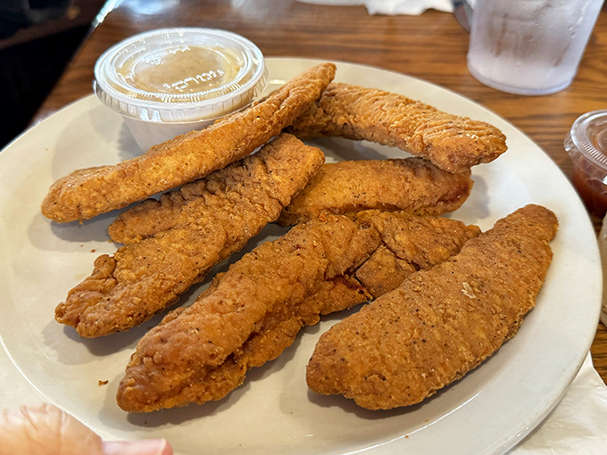 Chicken tenders that actually taste like chicken—what a concept! Crispy, golden, and begging to be dunked in that side of sauce.