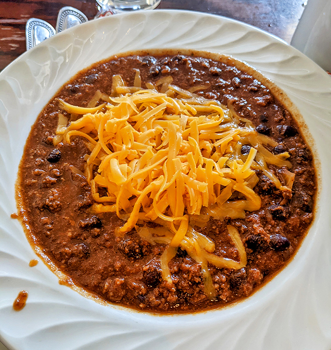 A bowl of chili that doesn't just warm your stomach but your soul. The melted cheese on top is like a cozy blanket for your taste buds.