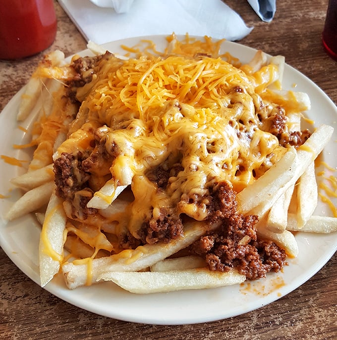 Chili cheese fries that laugh in the face of diet culture—a glorious mess of crispy potatoes, savory beef, and melted cheese.