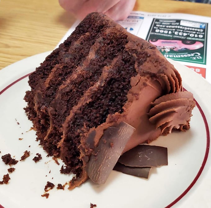 A slice of chocolate cake so rich it should come with its own tax bracket. Those layers aren't just dessert&mdash;they're therapy.