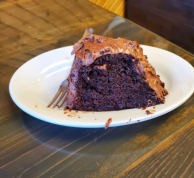 A slice of chocolate cake so rich and decadent it should come with its own tax bracket and financial advisor.