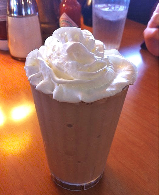 A milkshake with whipped cream stacked so high it needs its own zip code &ndash; dessert masquerading as a beverage.