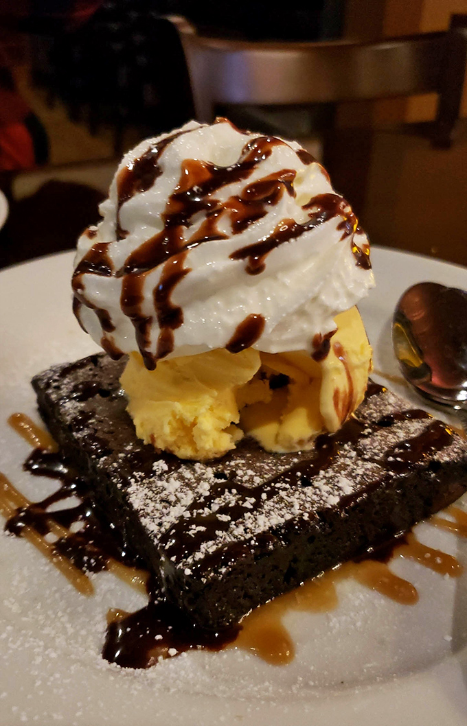 Dessert nirvana achieved: a warm chocolate brownie crowned with ice cream and drizzled with caramel&mdash;proof that happiness can indeed be served on a plate.