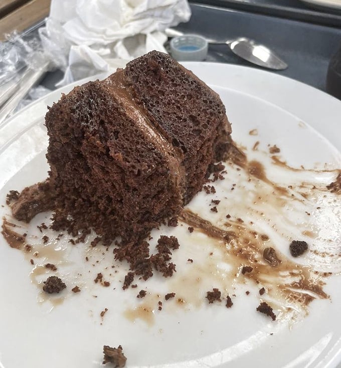 Chocolate cake so moist and rich it should require a permit. This isn't dessert; it's an emotional experience with a fork.