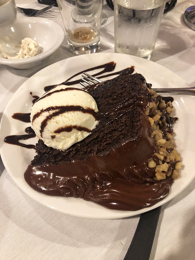 The grand finale: a slice of decadent chocolate cake swimming in fudge sauce with vanilla ice cream. Diet plans, consider yourselves postponed.