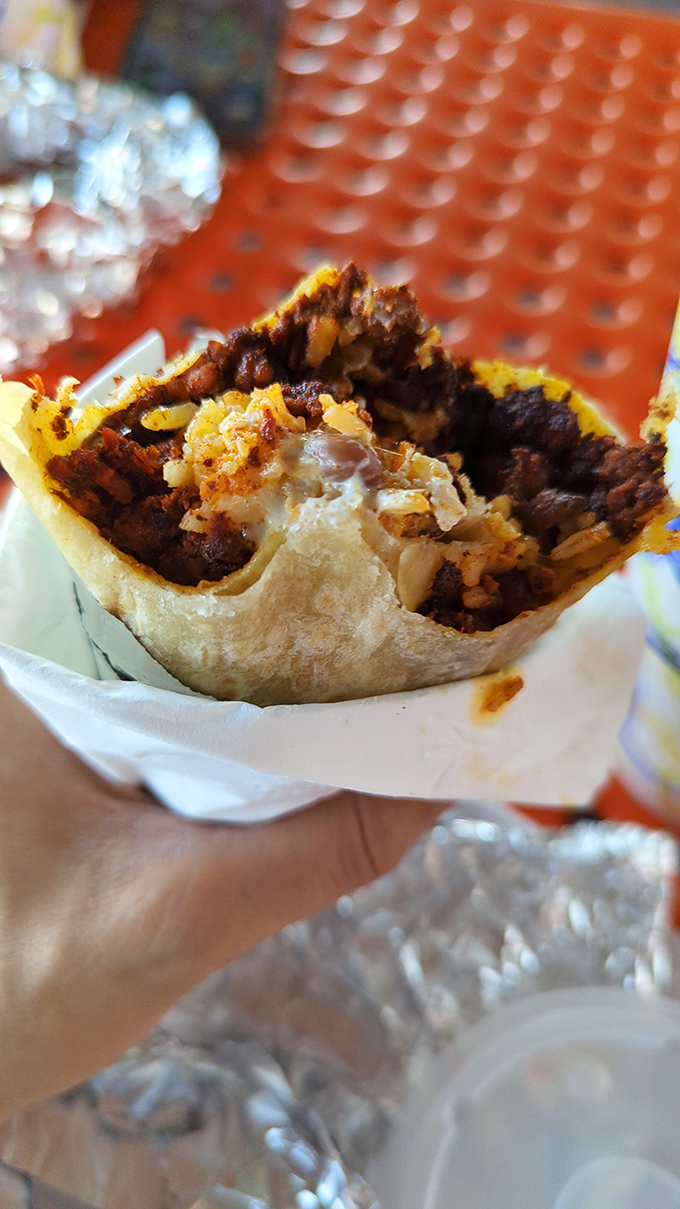 Behold the cross-section of happiness! This chorizo burrito reveals its secrets: perfectly seasoned meat, rice, and cheese melted into a harmonious union.