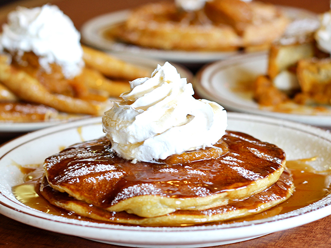 Pancake perfection in its natural habitat. Golden discs of joy topped with a crown of whipped cream and swimming in syrup&mdash;breakfast royalty if ever there was such a thing.