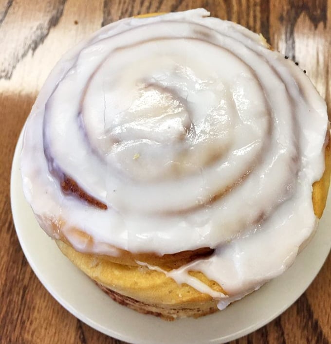 This cinnamon roll isn't just breakfast; it's a spiral-bound love letter to butter, sugar, and spice, glazed to glistening perfection.