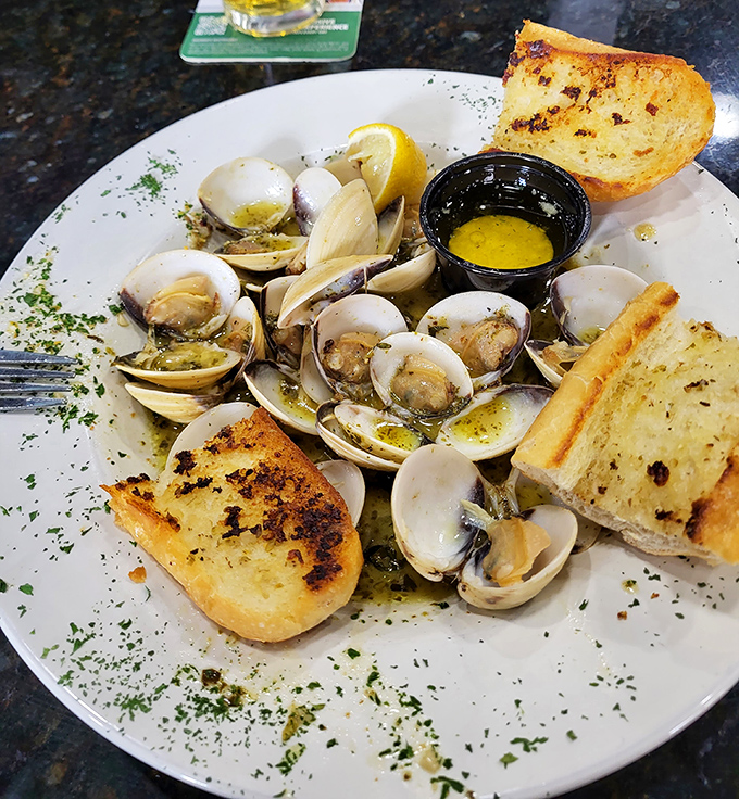 These clams, bathed in garlic butter and surrounded by toasted bread, are the ocean's gift to those wise enough to order them.