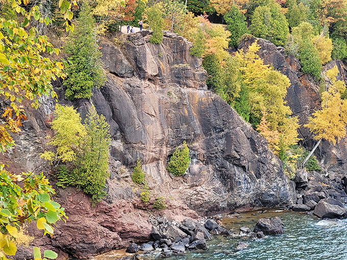 Fall transforms the cliff faces into a painter's palette of gold and crimson against dark stone.