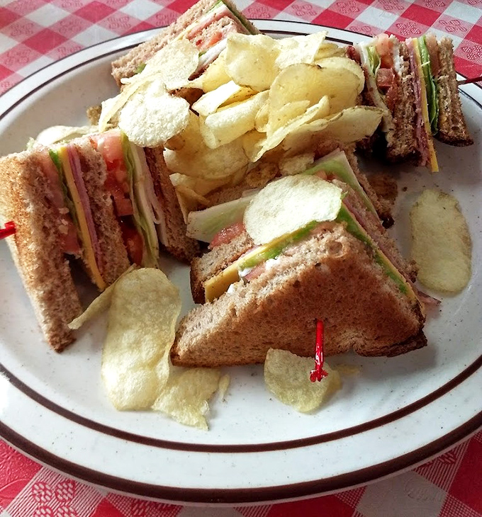 The club sandwich stands tall and proud, a three-tiered monument to the timeless combination of bread, meat, cheese, and veggies that never disappoints.