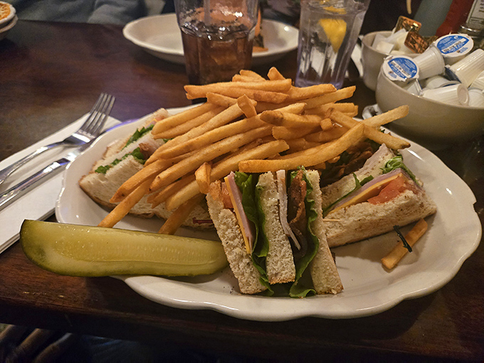 The club sandwich stands tall and proud, like a delicious skyscraper built by someone who understands structural integrity.