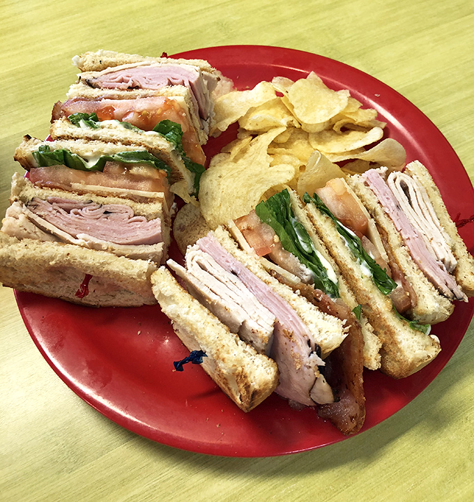 This club sandwich stands taller than most Florida condos and delivers more layers of flavor than your favorite mystery novel.