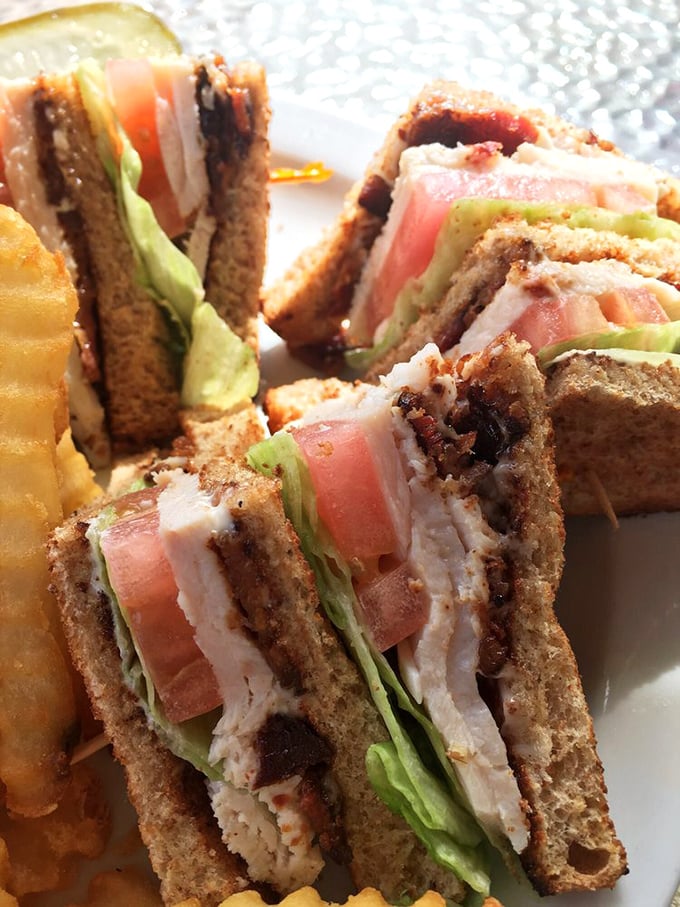 Club sandwiches are the unsung heroes of lunch menus, and this triple-decker masterpiece with its perfect toast-to-filling ratio proves why.