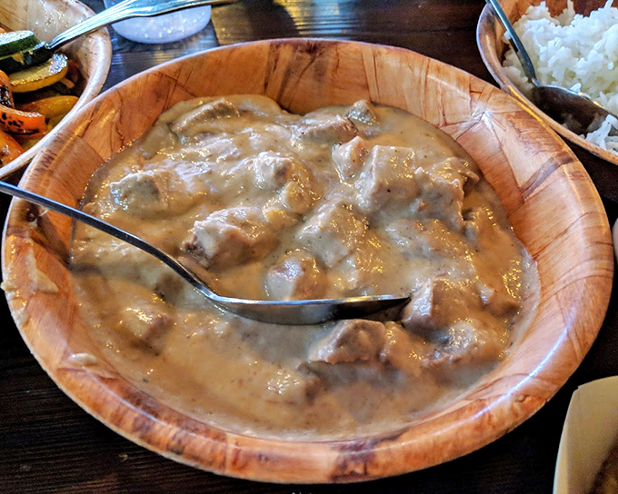 Coconut beef that's having a better day than you are. Swimming in creamy sauce that would make a French chef question their life choices.