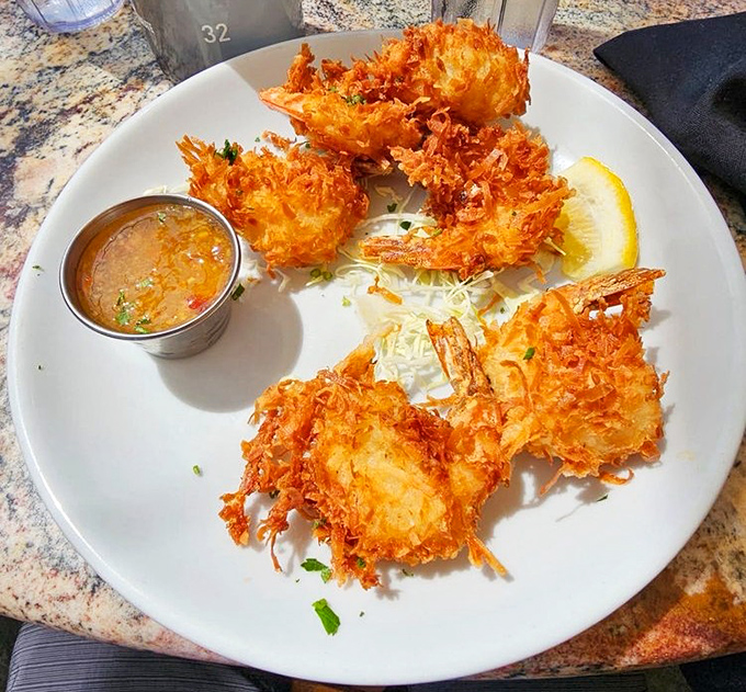 Coconut shrimp that look like they're wearing little tropical party outfits&mdash;crispy, sweet, and ready to transport you to island time with one bite.