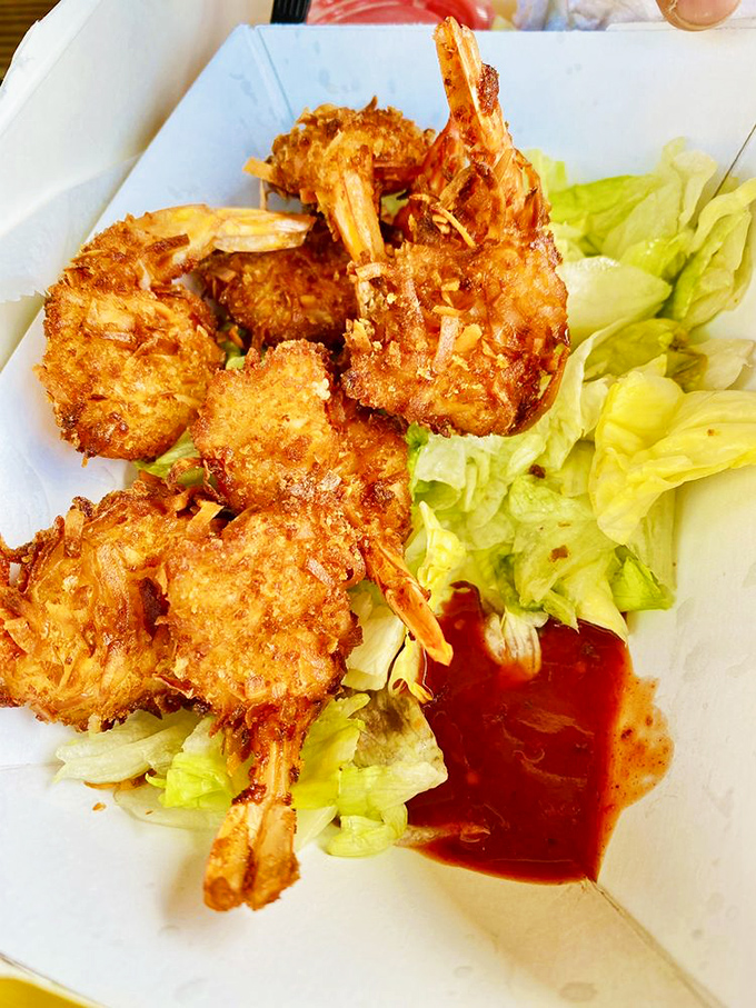 Coconut shrimp that actually taste like coconut. These crispy crustaceans perched on fresh lettuce prove simple food done right beats fancy food done wrong every time.