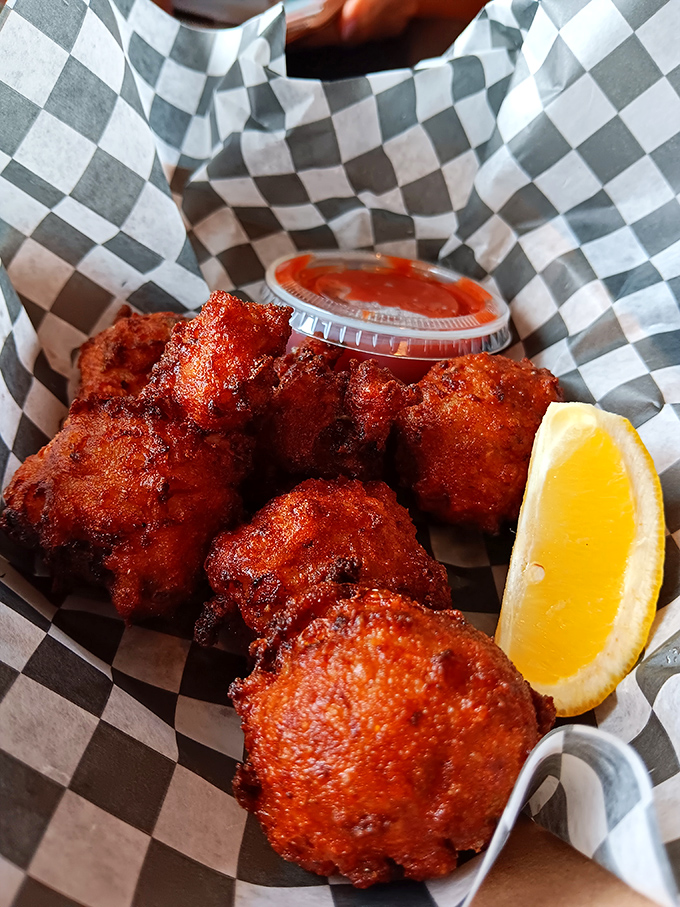 These conch fritters look like they've been kissed by the fryer gods &ndash; crispy, golden-brown orbs of Florida tradition served with a side of sass.