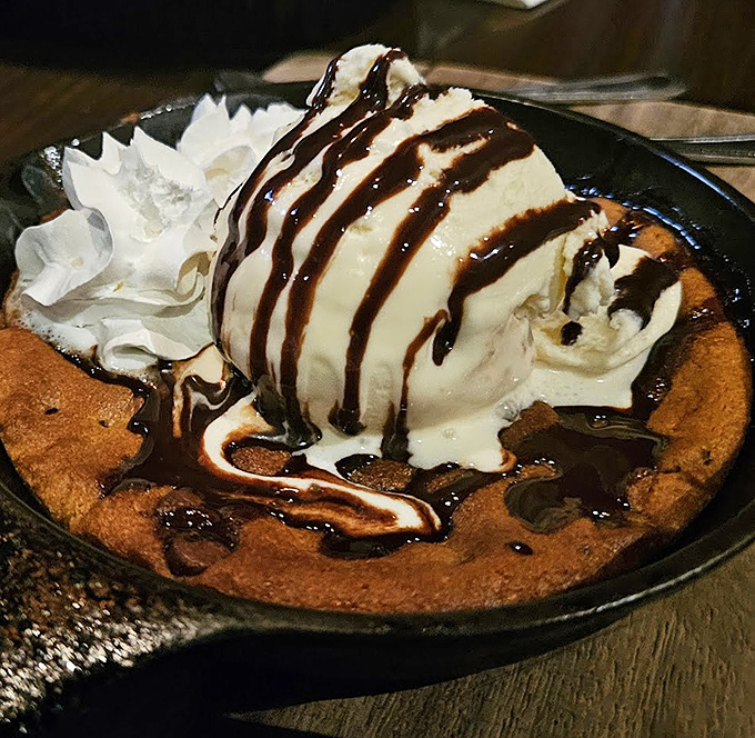 The skillet cookie sundae arrives like a warm hug after a long day&mdash;melting ice cream creating rivers of vanilla through valleys of chocolate. Spoons ready for battle!