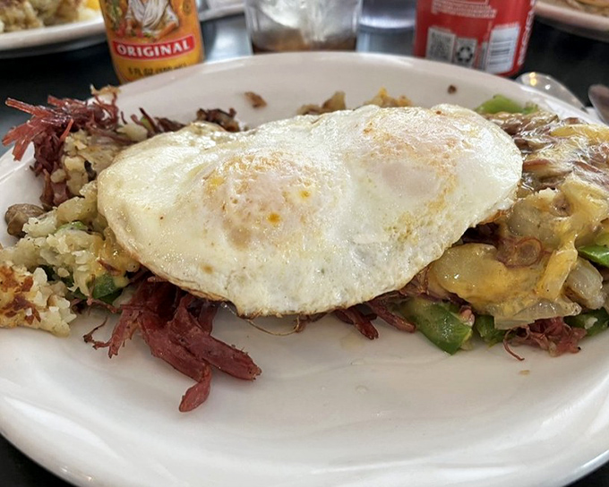 This isn't just a hash &ndash; it's a beautiful chaos of potatoes, corned beef, and vegetables, crowned with an egg cooked just right.