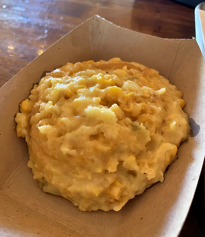 Aunt Susan's corn casserole looking like comfort in a cardboard container – creamy, corny, and calling your name.