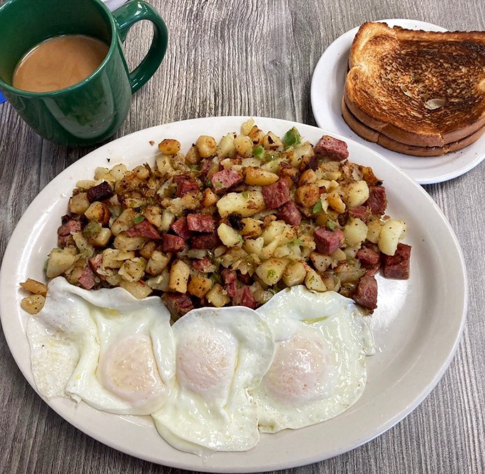 Coffee in a classic green mug—the unsung hero of every Bomber breakfast, keeping you alert enough to tackle those massive portions.