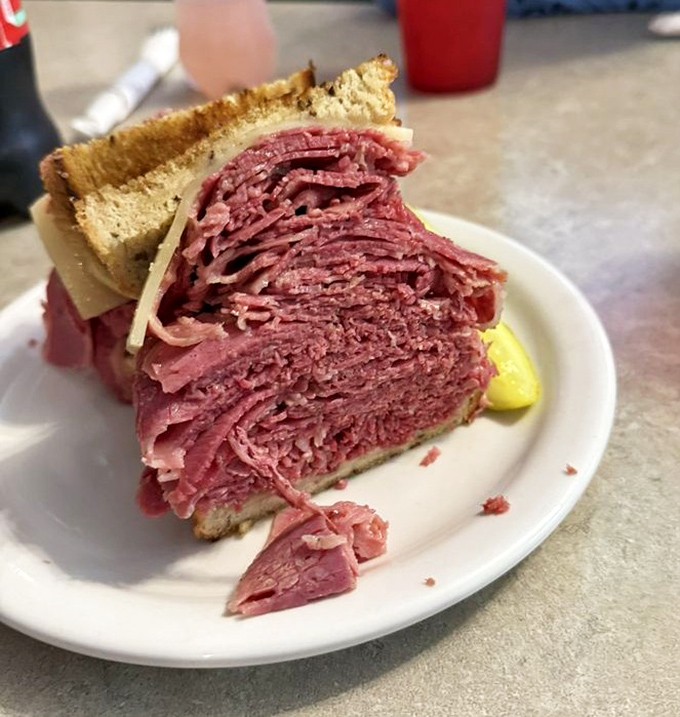 Behold the cross-section of a proper corned beef sandwich&mdash;where "generous portion" becomes a hilarious understatement.