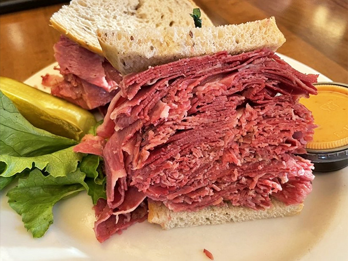 The corned beef doesn't just fill the sandwich&mdash;it erupts from it, a glorious pink mountain that makes you wonder if you should photograph it or climb it. 