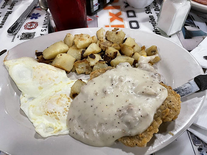 Country fried steak smothered in pepper gravy alongside sunny-side-up eggs. Not diet food, but definitely worth the extra mile on tomorrow's walk.