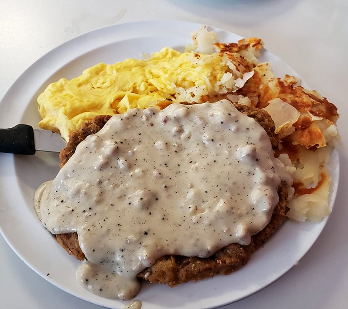 Country fried steak smothered in gravy so good you'll want to write poetry about it&mdash;or at least lick the plate when nobody's looking.