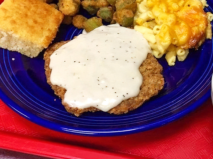 Country fried steak smothered in pepper gravy alongside mac and cheese&mdash;Southern comfort that hugs you from the inside.